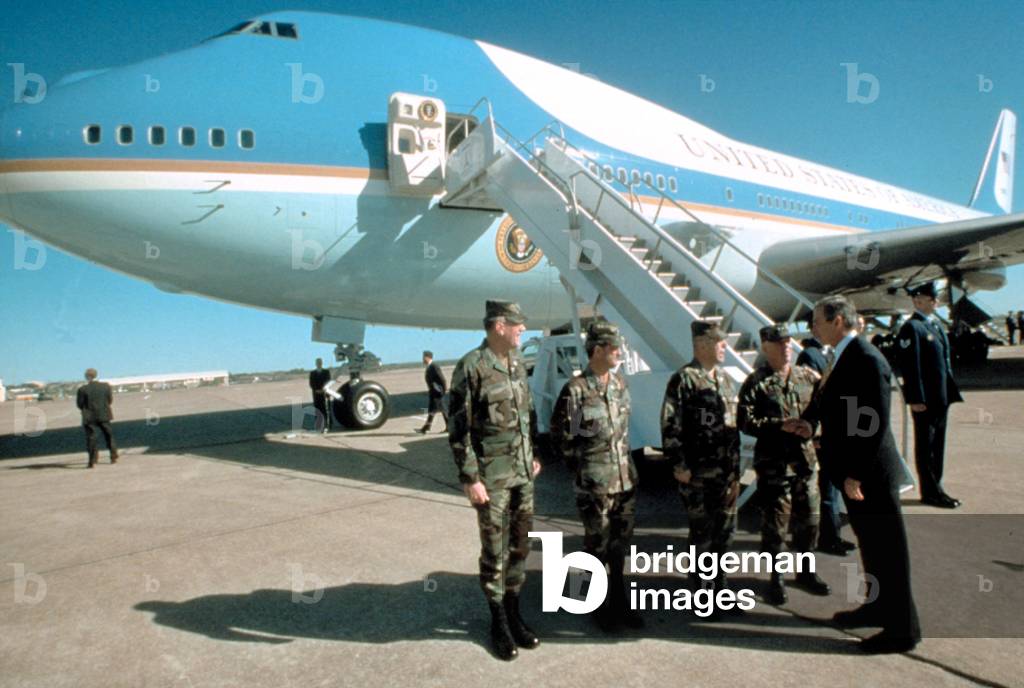 Image of President George W. Bush, talking with the crew members of