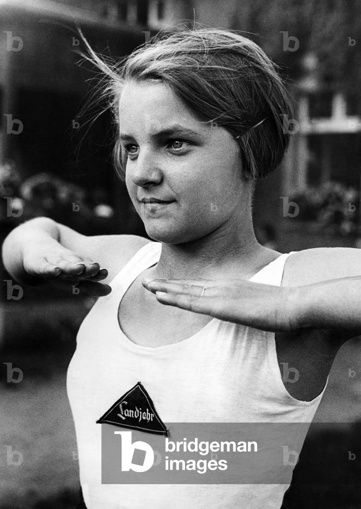 Image of BDM girl during warm-up exercise, 1934 (b/w photo)