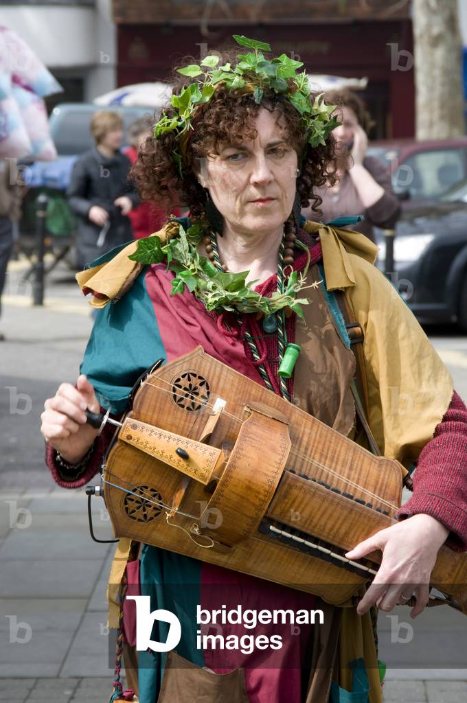 Image of Woman playing a hurdy gurdy by Walden, Gerry