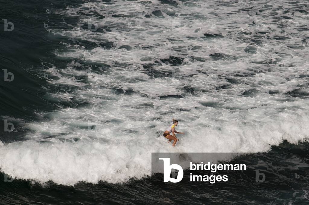 Image of Surfer on the beach between Kahakuloa and Honokohau, Maui, Hawaii