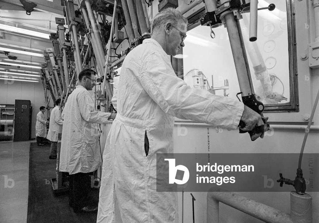 Image of Technician handles radioactive materials using remote handling ...