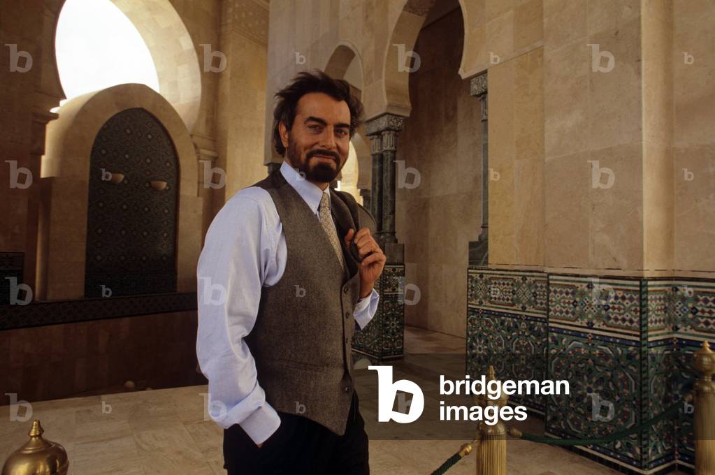 Image of Kabir Bedi with the jacket over his shoulder in the
