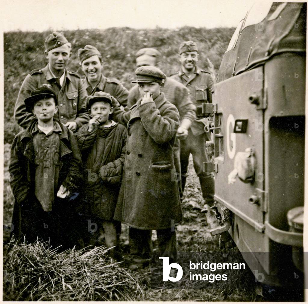 Image of German Soldiers giving children cigarettes, c.1942 (photo)