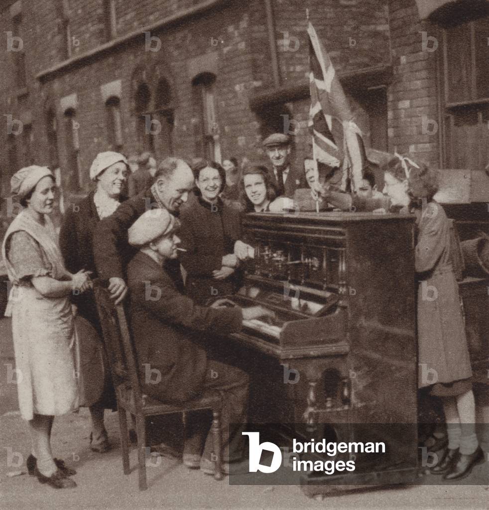 Image of People enjoying a tune on a piano saved from a by English ...
