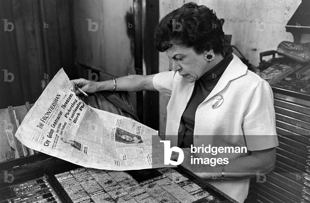 Image of Editor of the Frontiersman newspaper inspects a page proof ...
