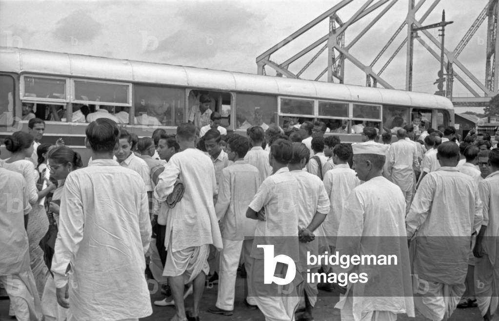 Image of People jumping on a overflowing bus, Kolkata, India, 1962 (b/w