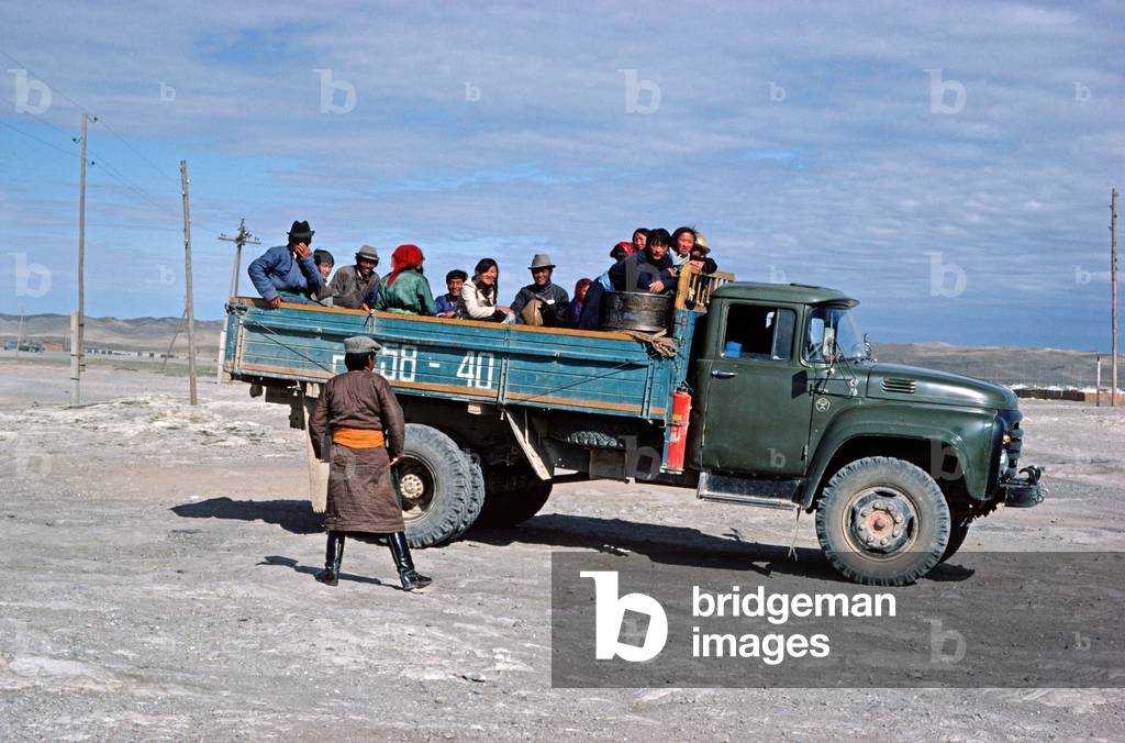 Image of Mongolians back of truck, transport to various out of way