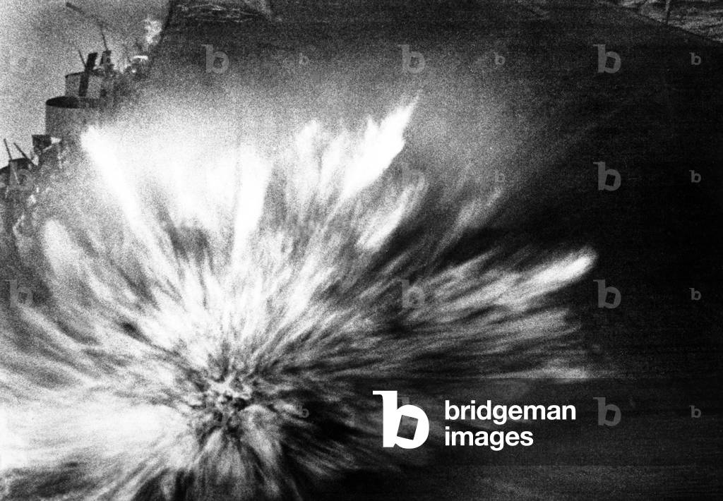 Image of A Japanese bomb explodes on the flight deck of the