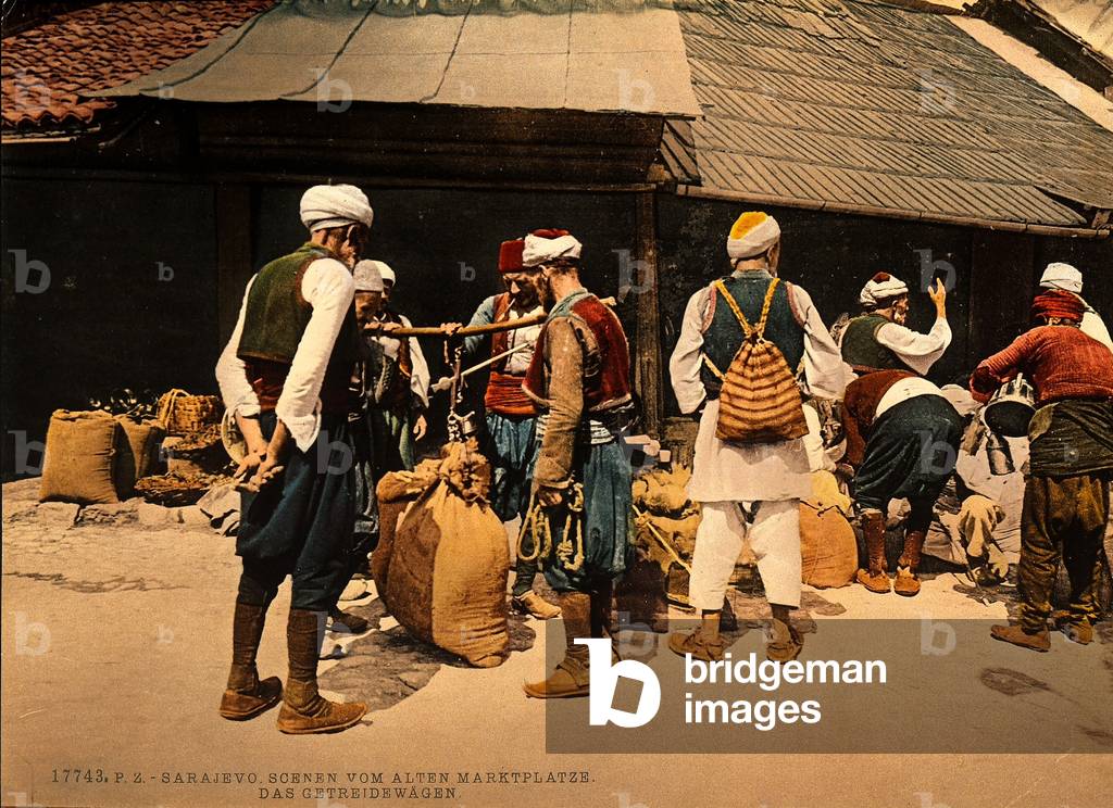 Image of Men in traditional dress, weighing sacks of cereal, Sarajevo ...