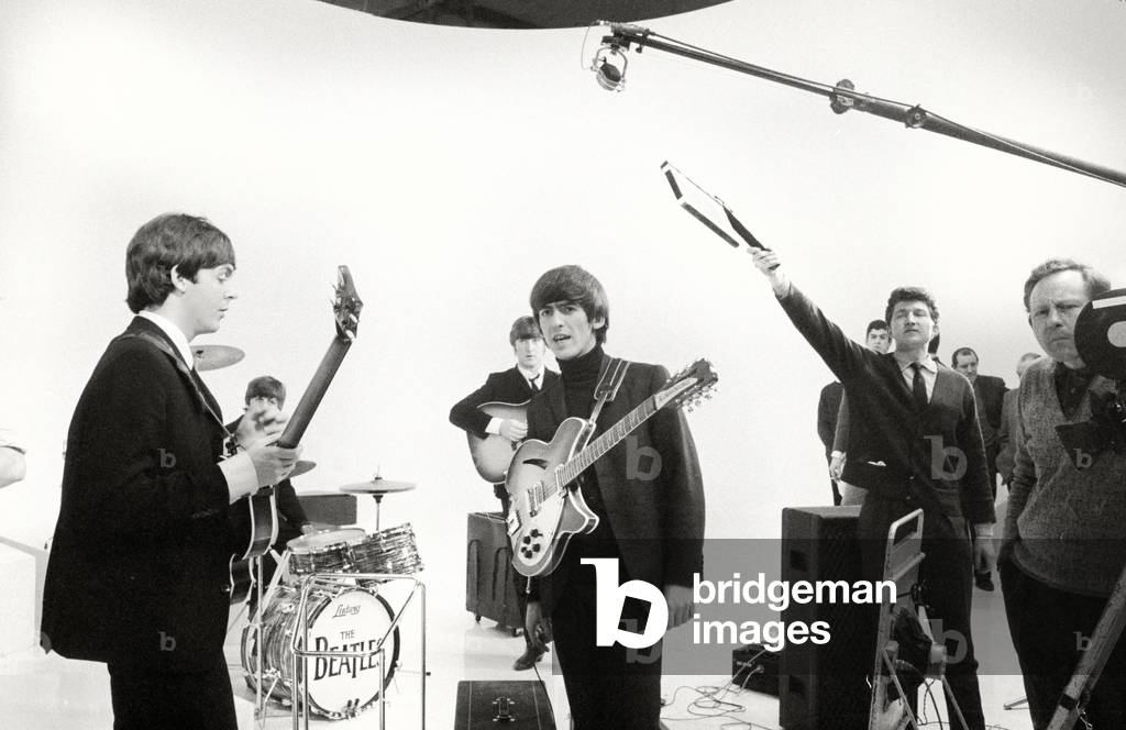 Image of The Beatles on a set of a TV studio for