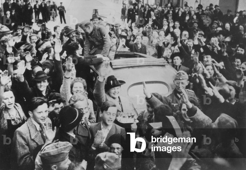 Image of Ethnic Germans cheer German Wehrmacht soldiers, 1941 (b/w photo)