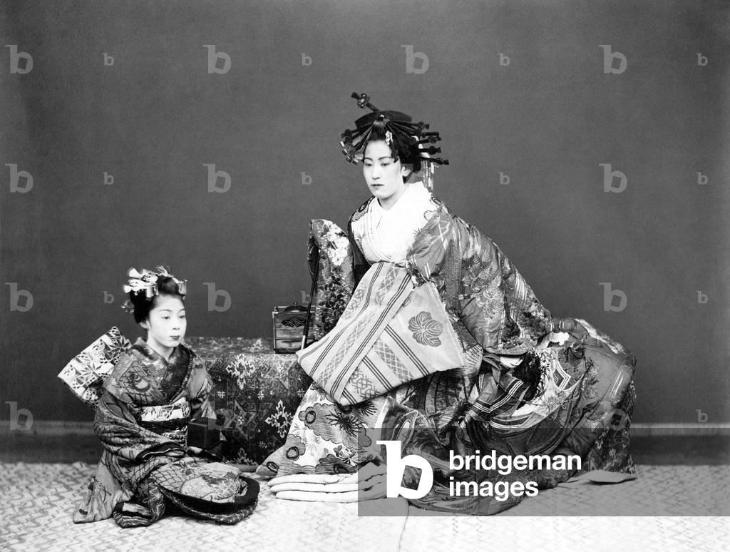Image of Japan: Studio portrait of an oiran or courtesan with her