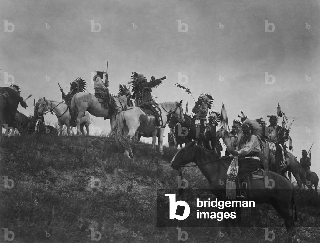 Image of PLANNING A RAID, 1907, photograph by Edward Curtis. The photo ...
