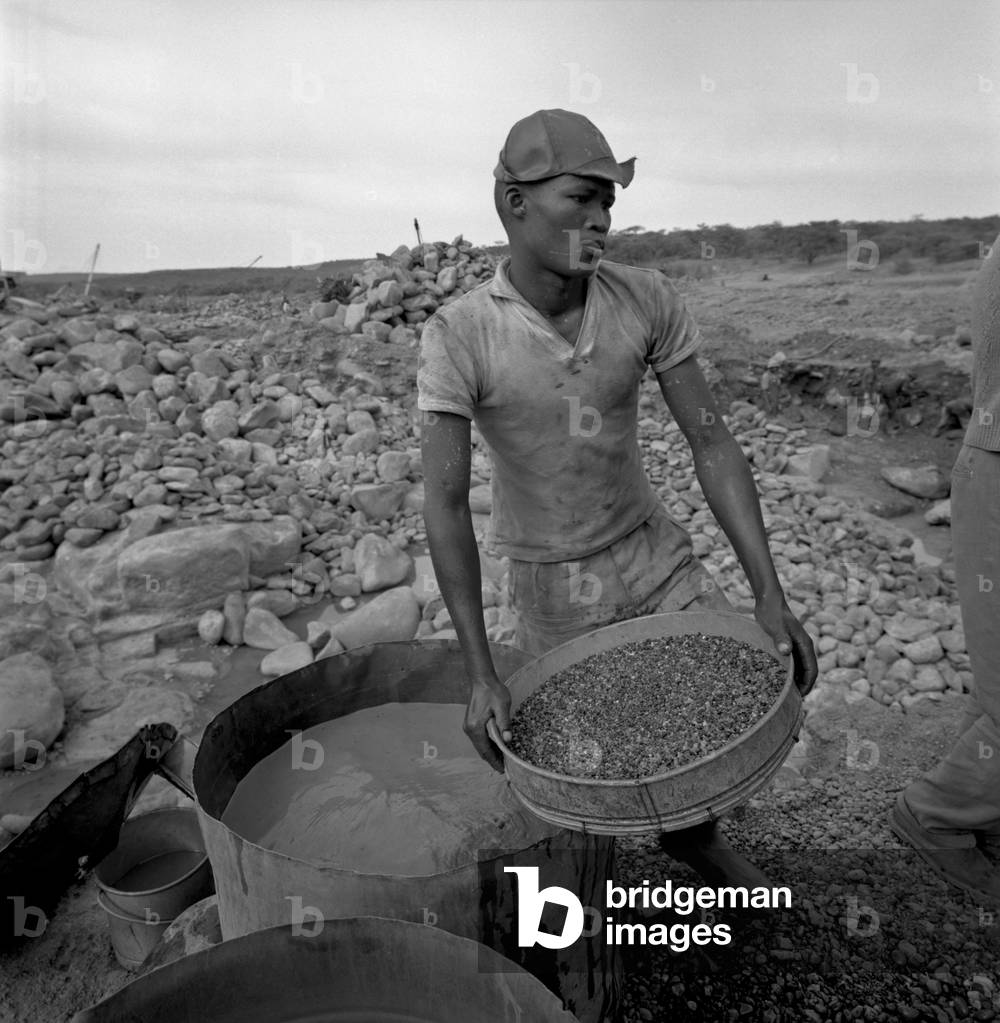 Image of A boy sifting the soil in a diamond mine, Republic