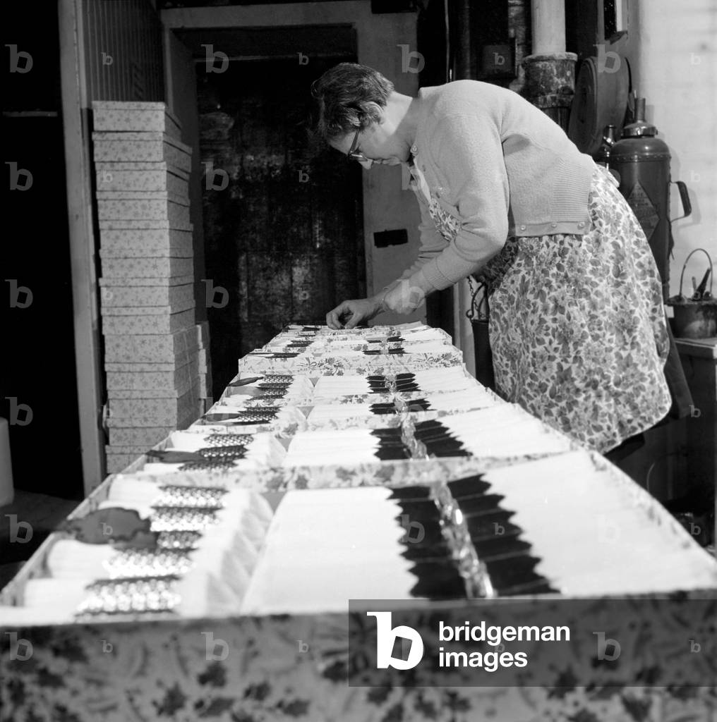 General scene in and around a Christmas cracker factory, where women ...