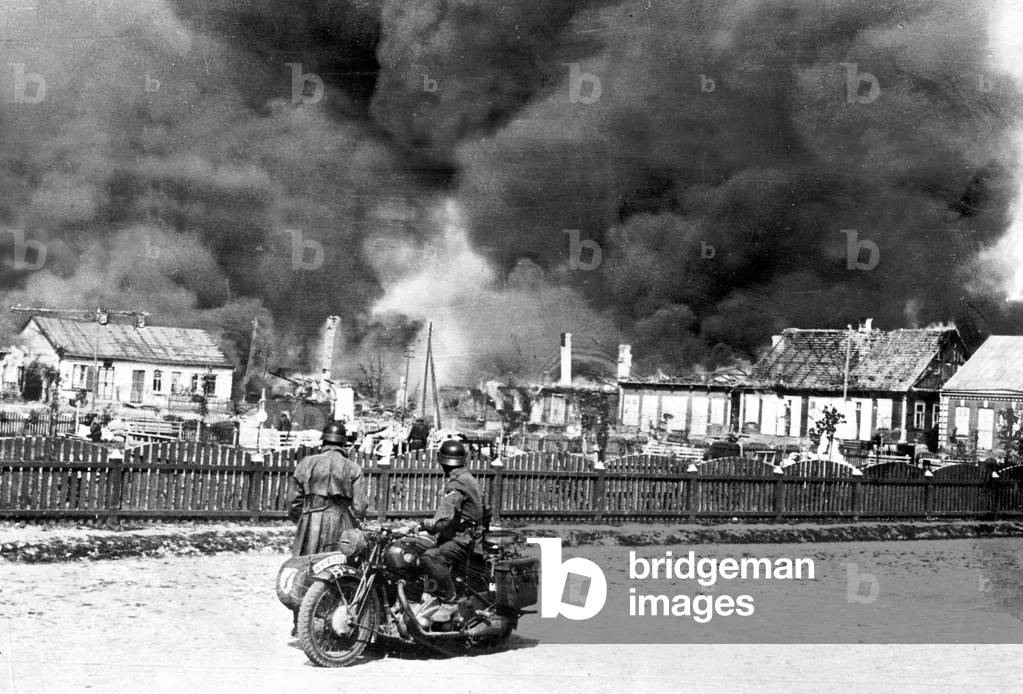 Image of German dispatch rider observes clouds of smoke over Orel, 1943