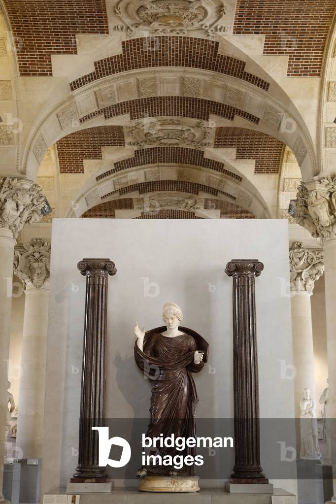 Image of Louvre museum, Paris, France. Woman praying between two Ionic ...