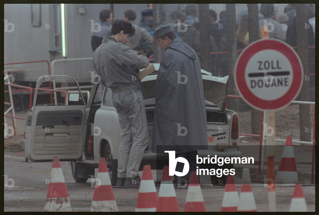 Image of East German shows East German customs officer contents of Trabant