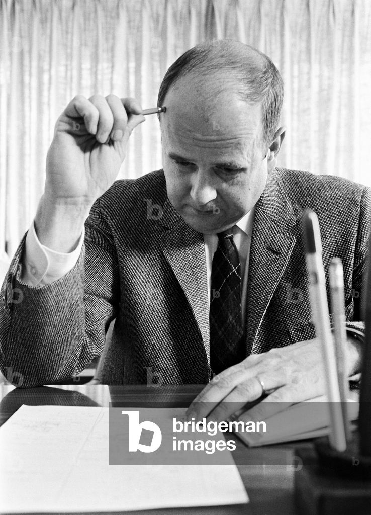 Image of Reverend Lincoln Reed of church writes and edits notes for by ...