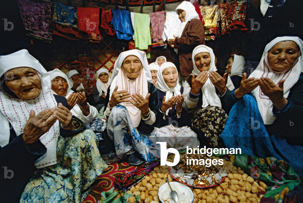 Image of In the village of Akesai, elderly Khazak women turn their by ...