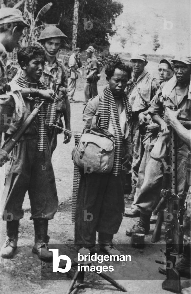Image of Two captured Indonesian army soldiers, with bandoliers around ...