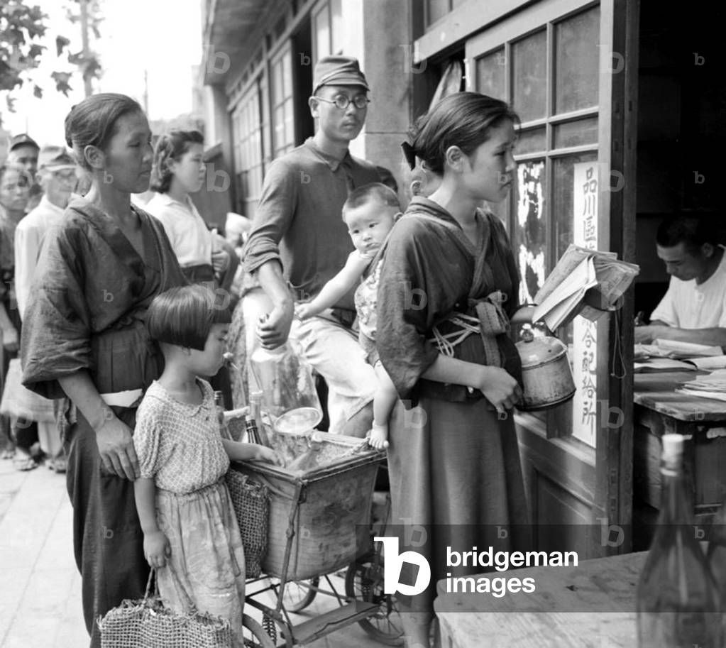 Image of Japan: Japanese queuing for rations of beans and water following