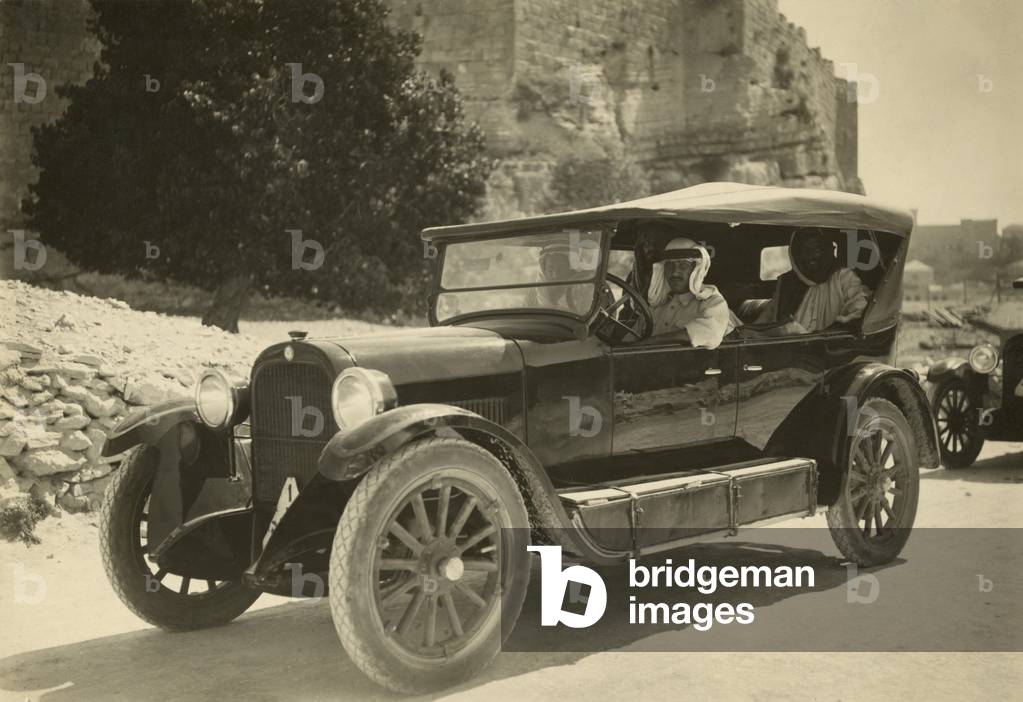 Image of Arab men wearing traditional keffiyeh in a passenger car in