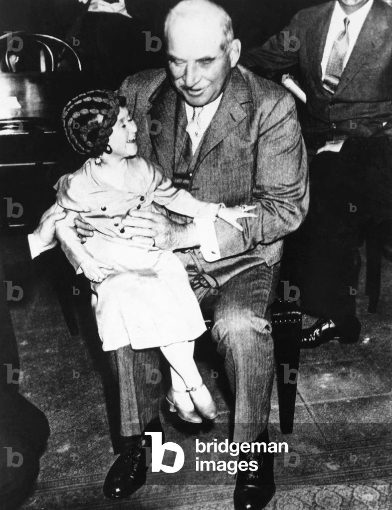 Image of Financier J.P. Morgan with circus midget Lya Graf sitting on