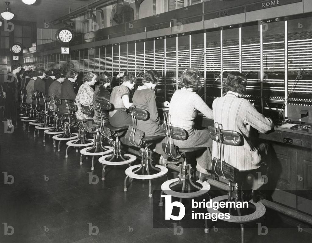 Image of Telephone operators working on an international switchboard in ...