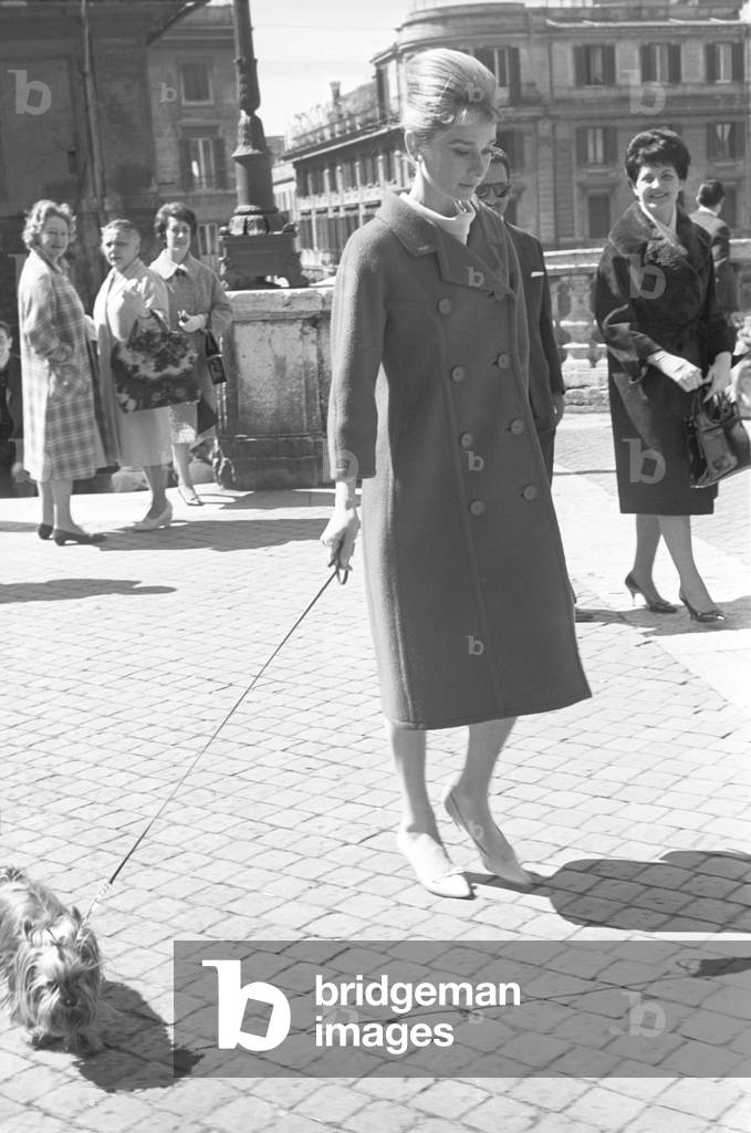 Image of Audrey Hepburn with a dog, Italy, 1961 (b/w photo)