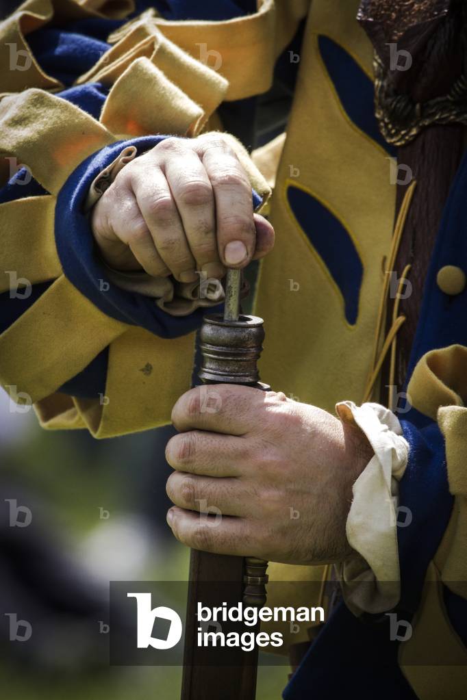 Image of Historical reenactment: Soldier loading matchlock arquebuse ...