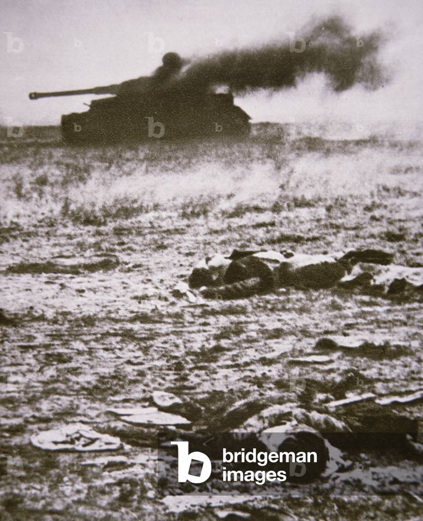 Image of A German Tiger tank burns with dead German soldiers in