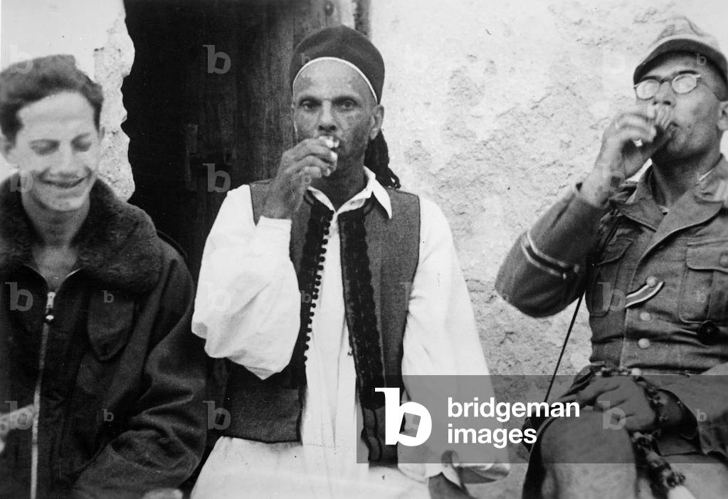 Image of German soldier drinks coffee with a local man, 1942 (b/w