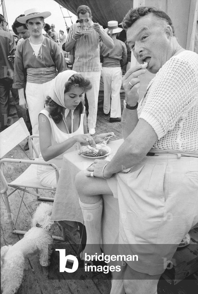 Image of Abbe Lane and Xavier Cugat eating during a boat trip,