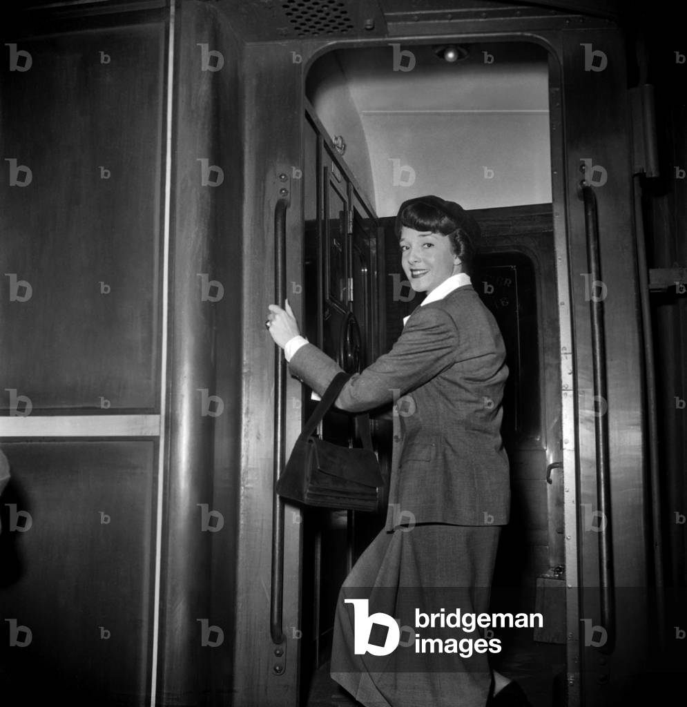 Image of French Actress Micheline Presle Taking Train in Paris To Go