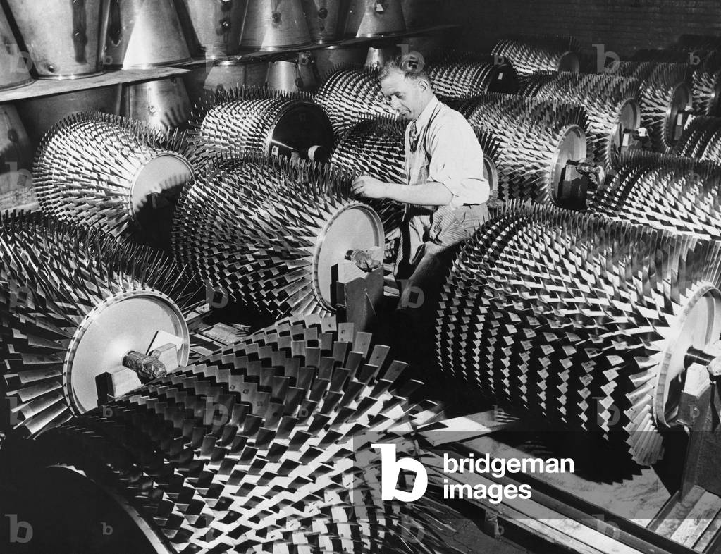Image of Manual worker working on compressor rotors in a jet engine