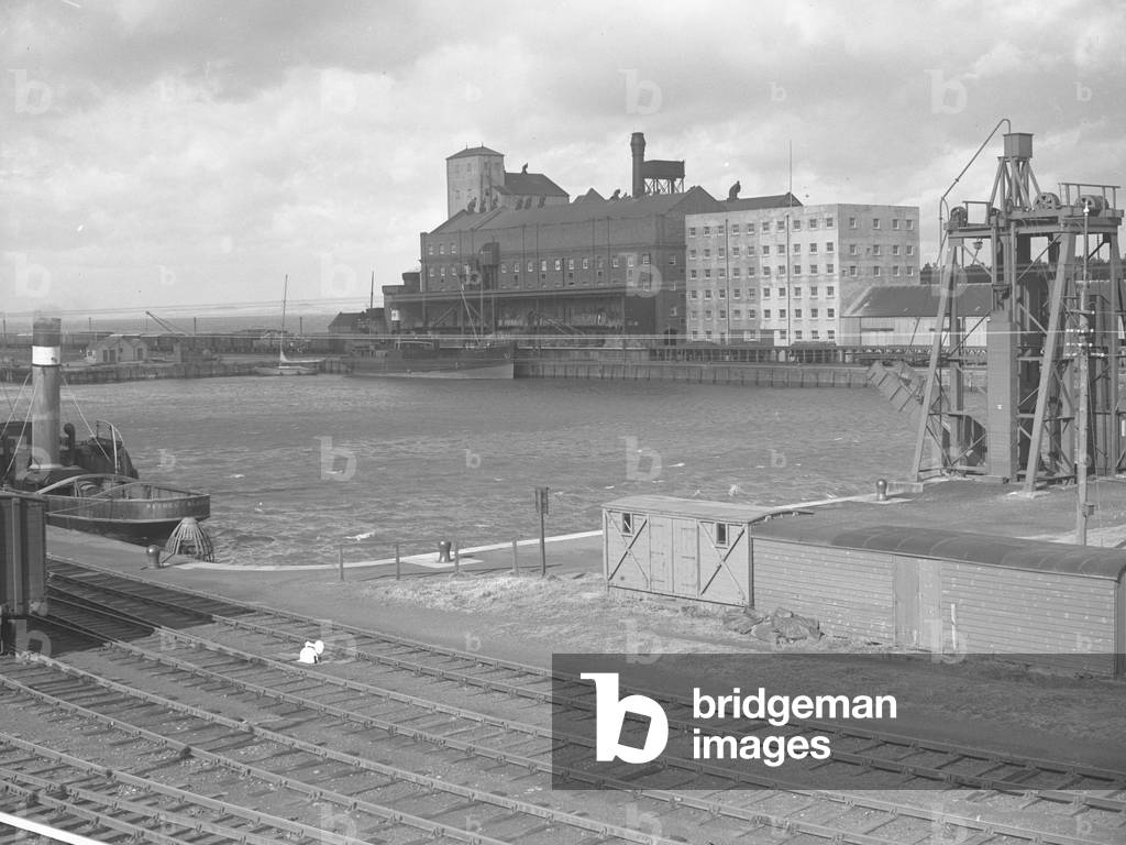 Image of A view of docks, boats, warehouses, machinary and railway ...