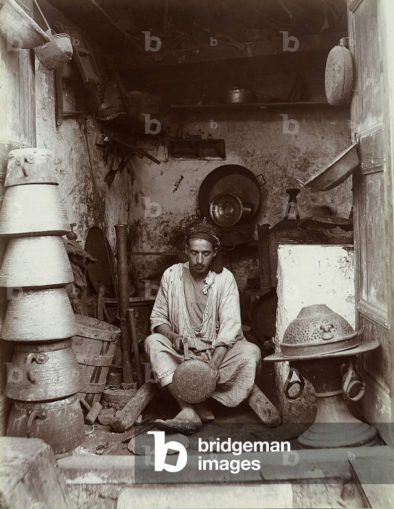 Image of A Turkish artisan forging and metal pot, 1890 (print on