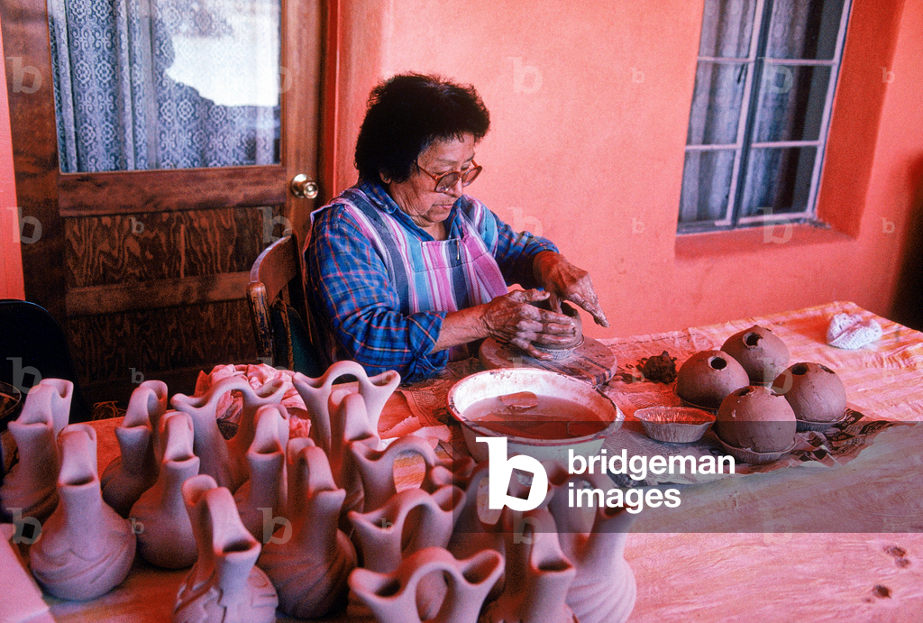 Image of Native American woman making traditional pottery. Santa Clara ...