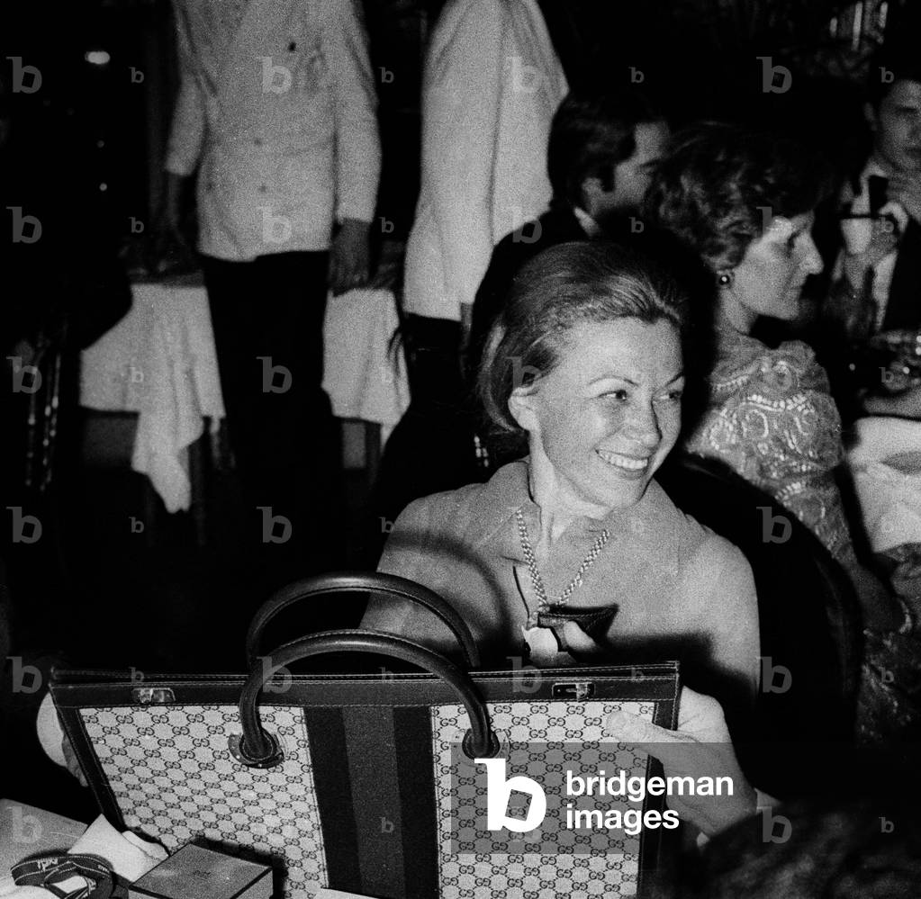Image of Rachel Dayan with a present during a party given