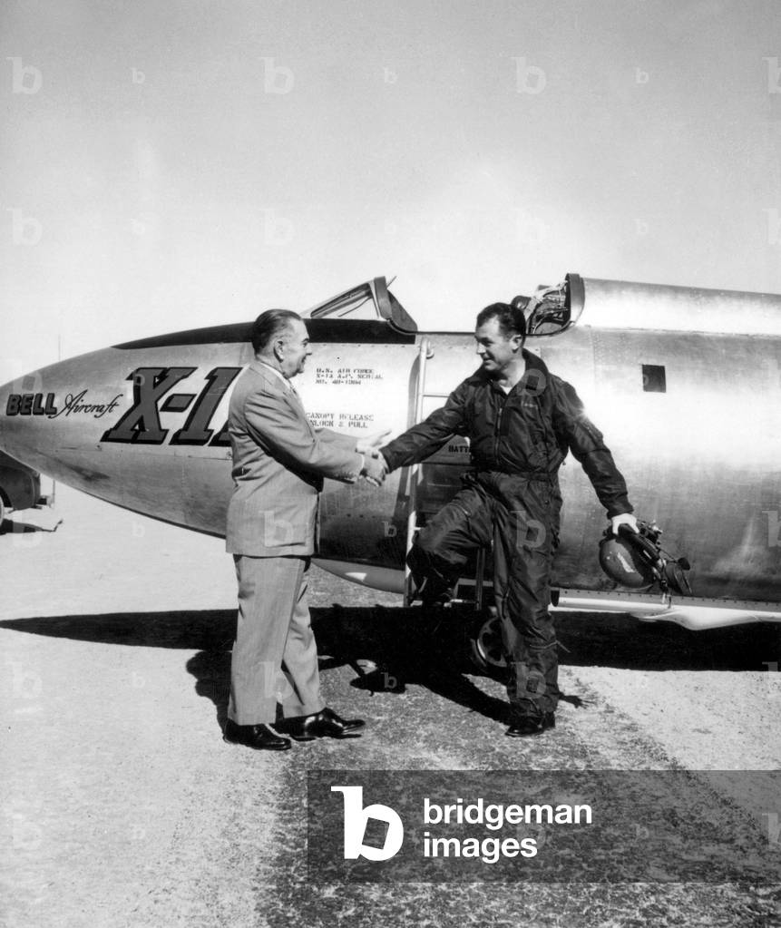 Image of Bell Director and Pilot Chuck Yeager shake hands in front by ...