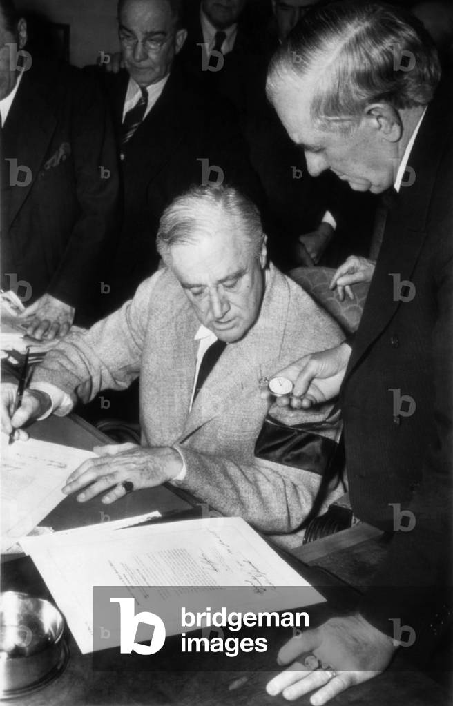Image of President Franklin D. Roosevelt (sitting), signing the ...