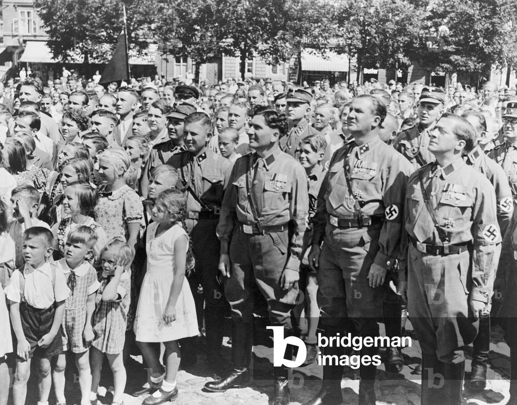 Image of Crowd of Germans adults and children, some dressed in Nazi